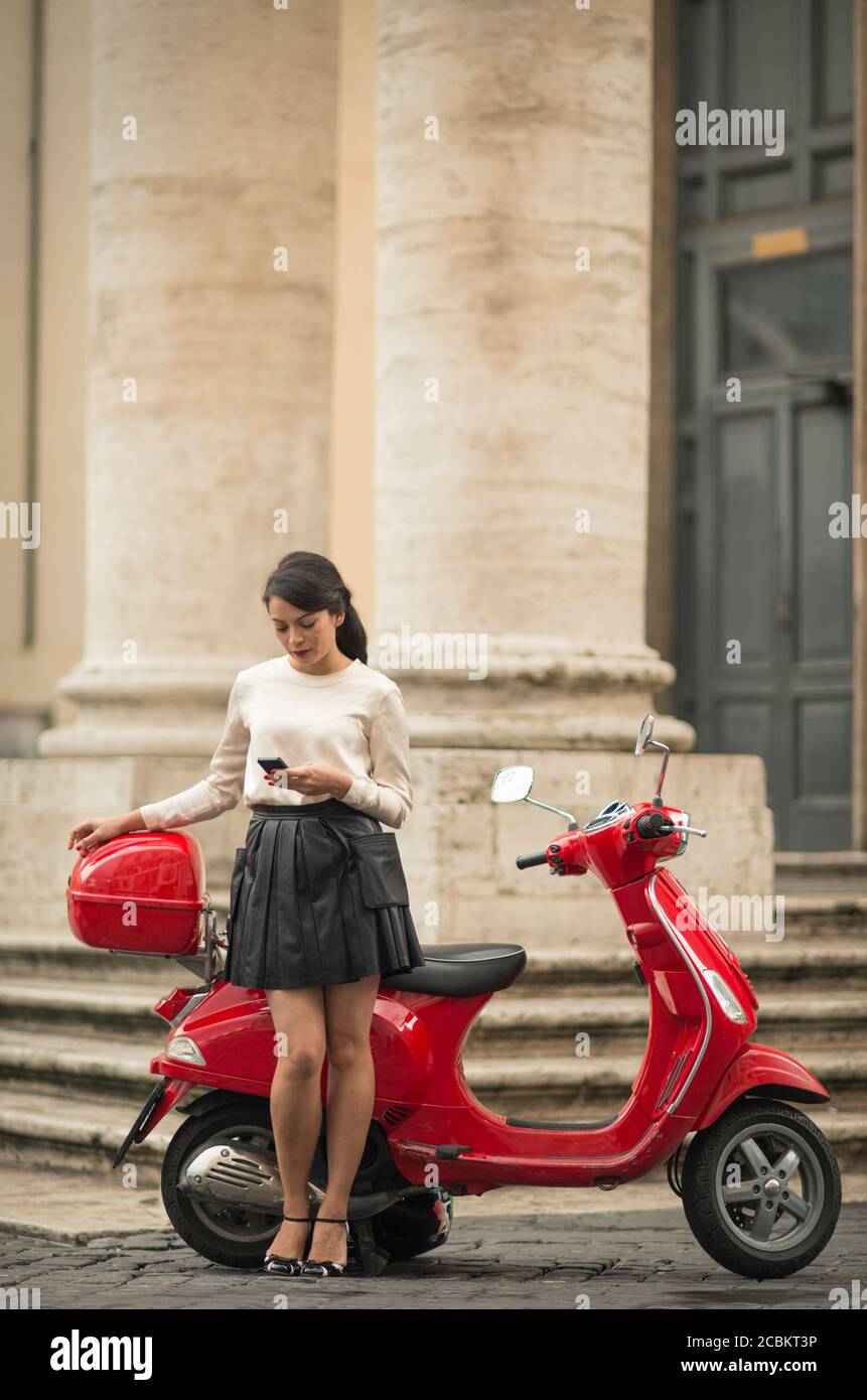 Young woman waiting by moped, Piazza del Popolo, Rome, Italy Stock ...