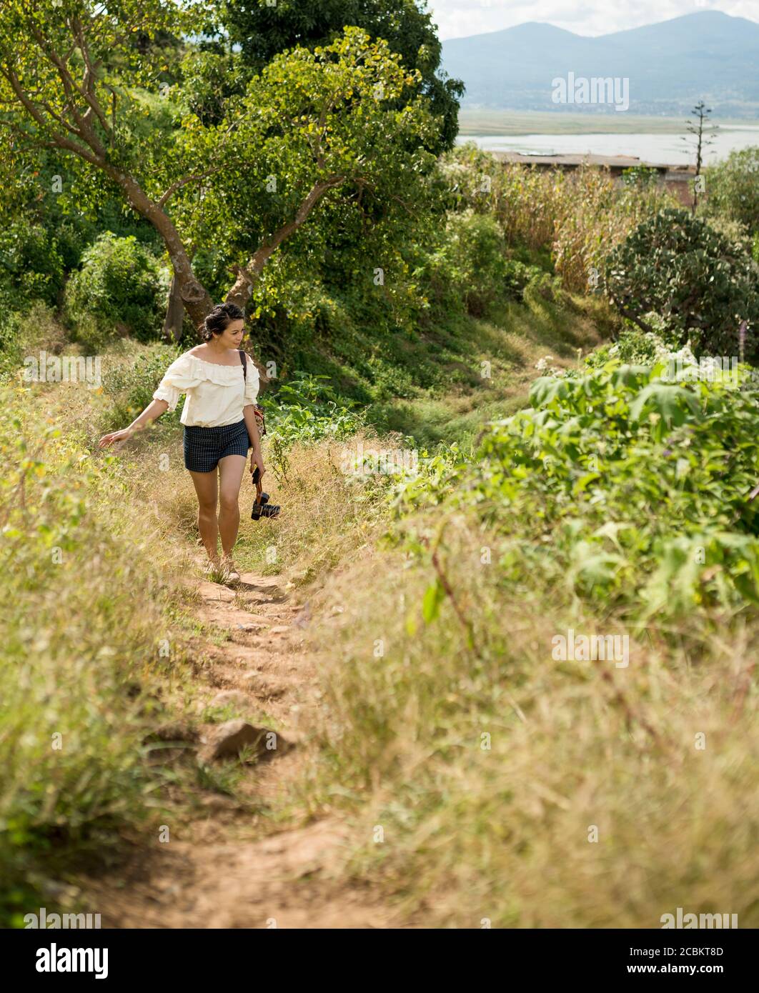 Female tourist strolling with camera, Isla Janitzio, Lake Patzcuaro ...