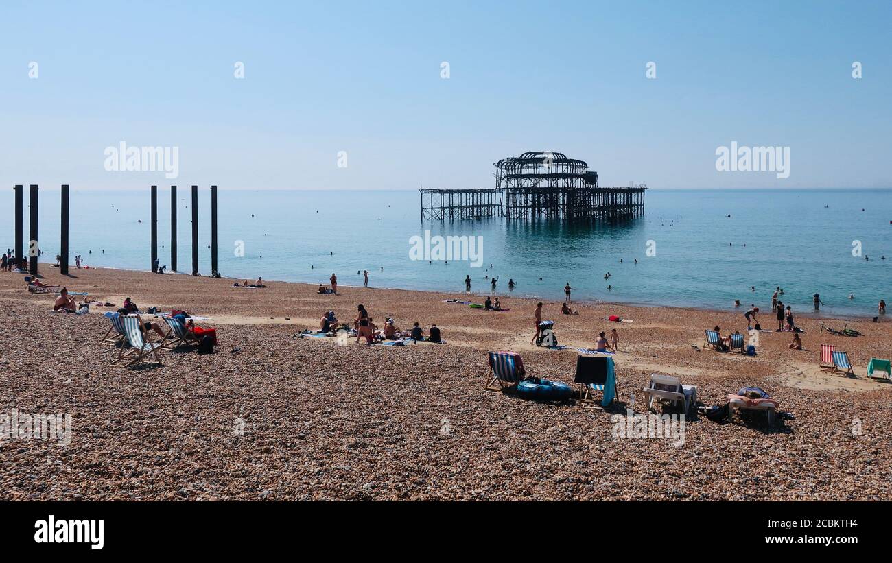 Brighton and Hove, E Sussex, UK - August 2020: People in the sea and on ...