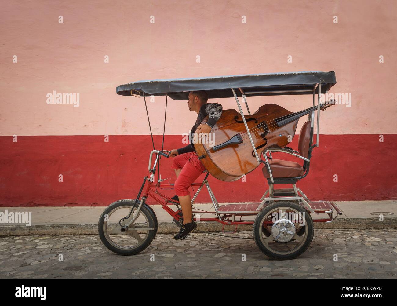 Man carrying double bass musical instrument hi-res stock photography ...