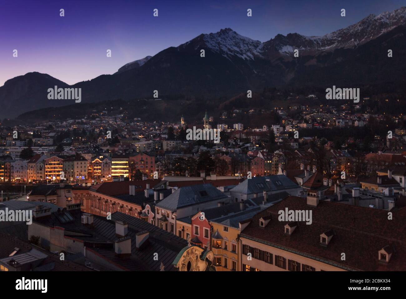Elevated cityscape with distant illuminated christmas market street at ...
