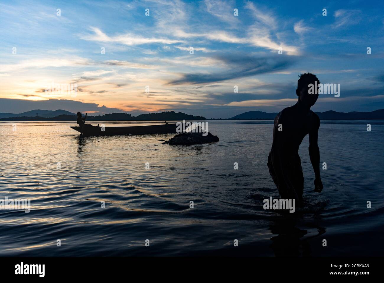 Guwahati, Assam, India. 14th Aug, 2020. Fisherman row his boat as a man ...