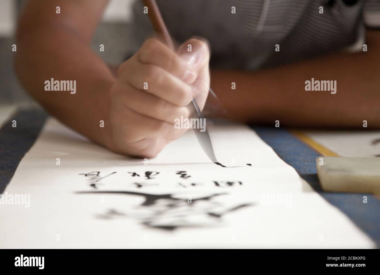 Calligrapher writing Chinese symbols on scroll Stock Photo - Alamy