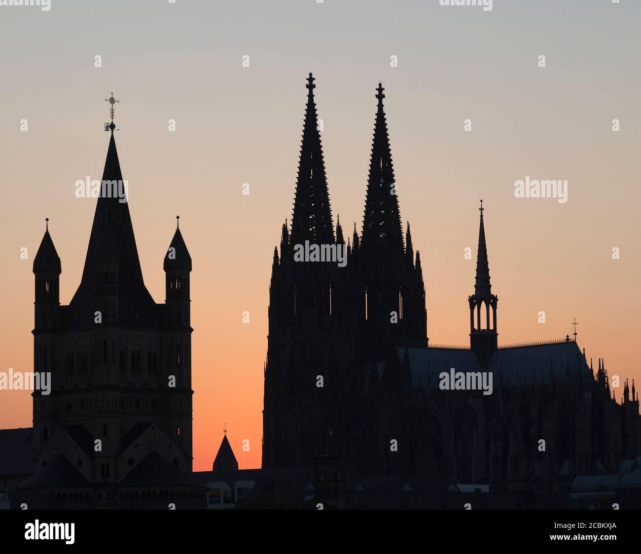 Silhouetted view of Great St Martin Church and Cologne Cathedral ...