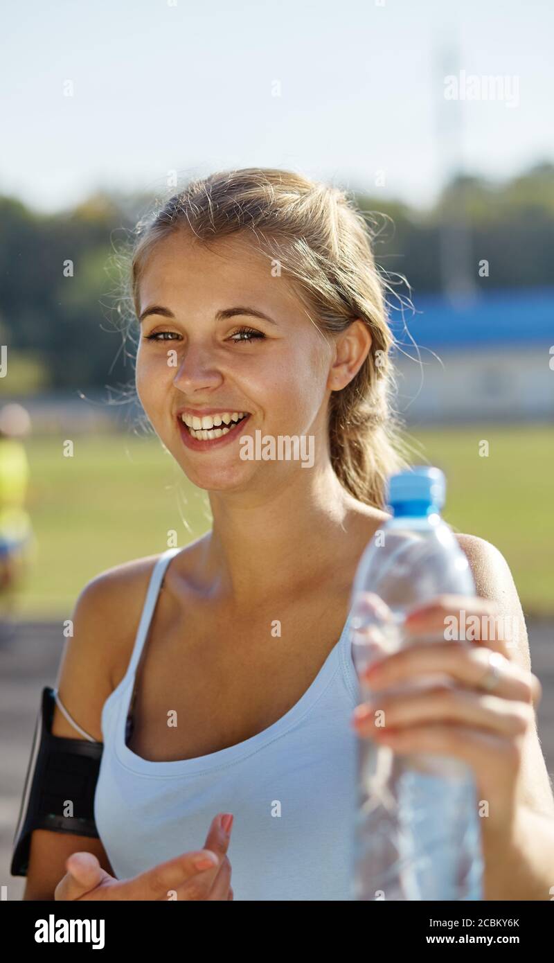 Beautiful sportsgirl in a stadium. Woman with bootle of water Stock ...
