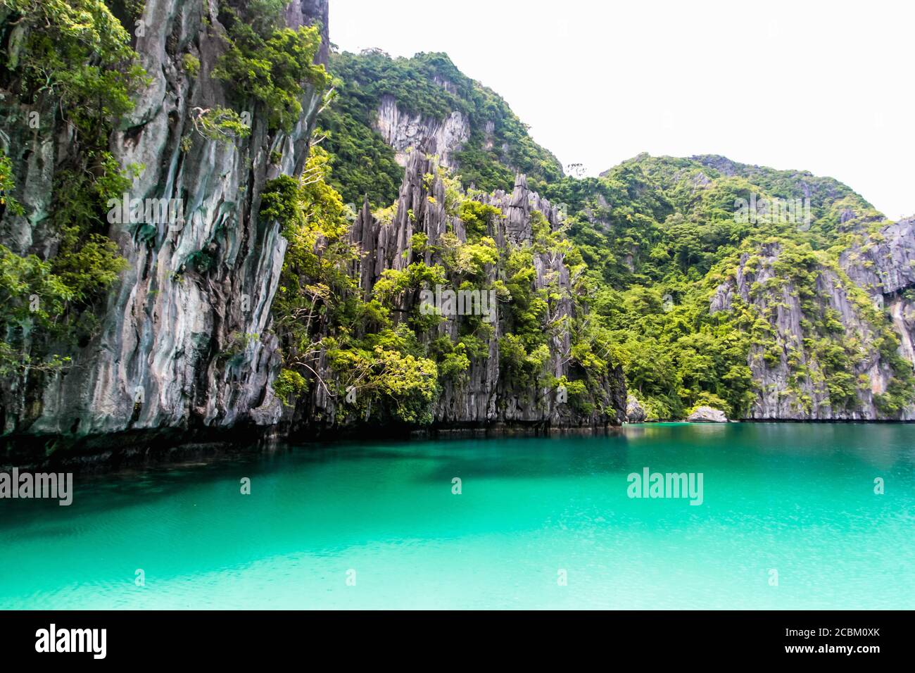 Secluded lagoon surrounded by beaches and high limestone cliffs near El ...