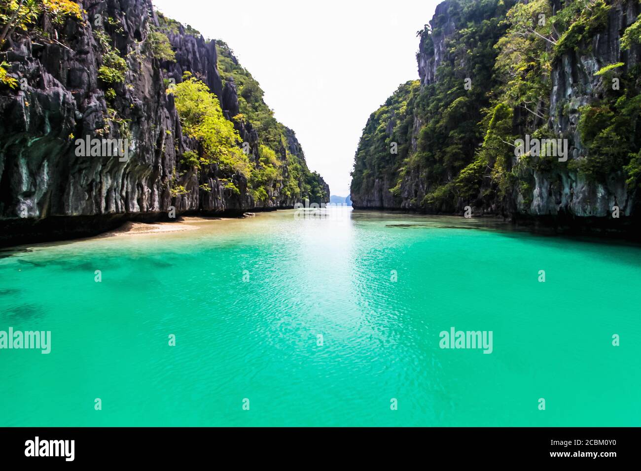 Secluded lagoon surrounded by beaches and high limestone cliffs near El ...