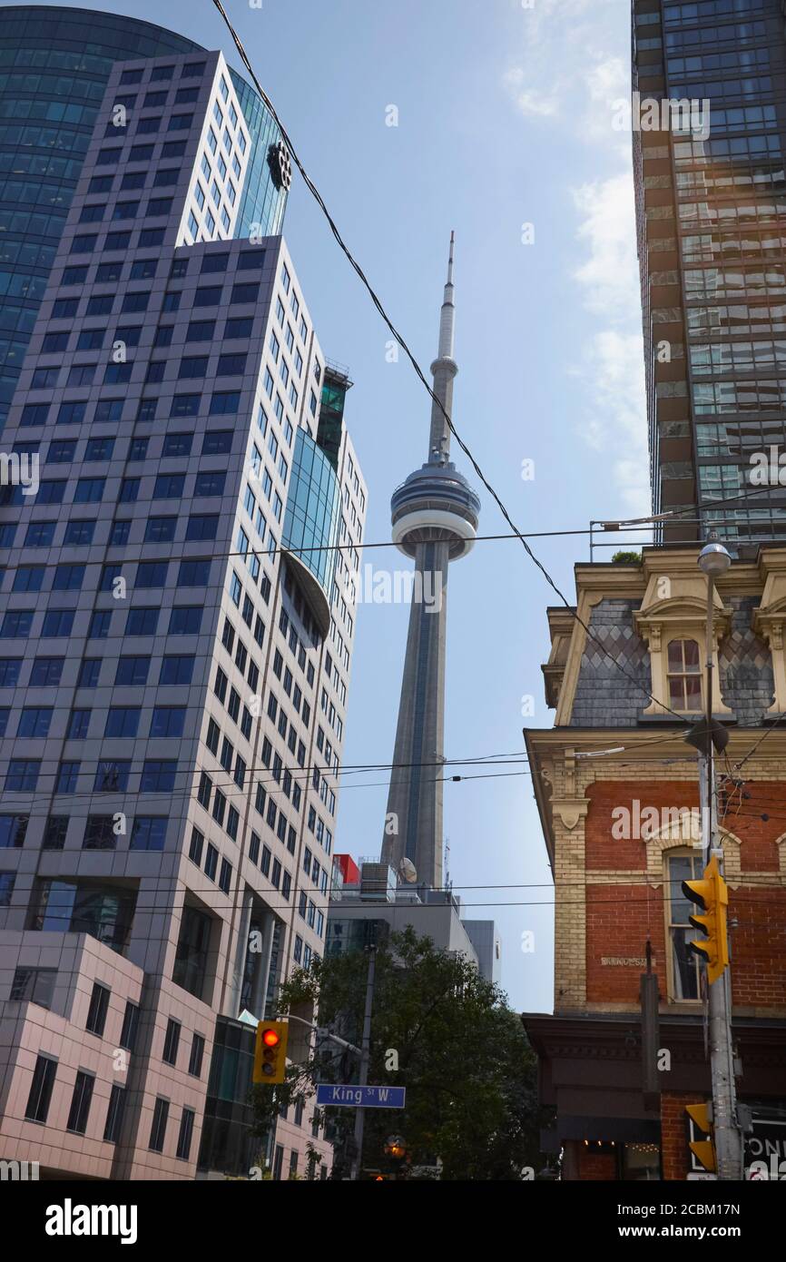 Low angle view of CN Tower between skyscrapers, Toronto, Canada Stock ...