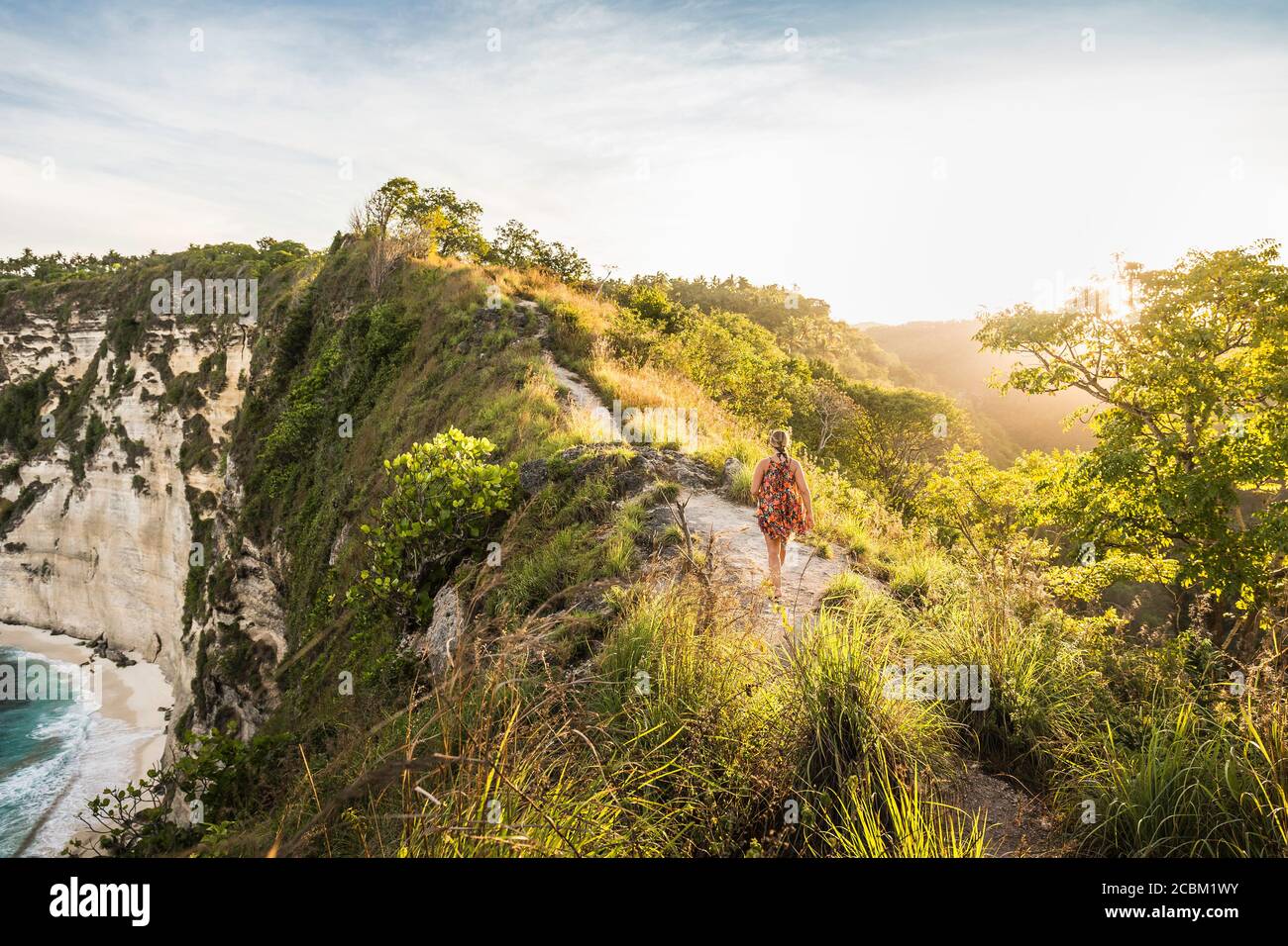 Tourist wandering on cliff, Nusa Penida, Bali, Indonesia Stock Photo ...