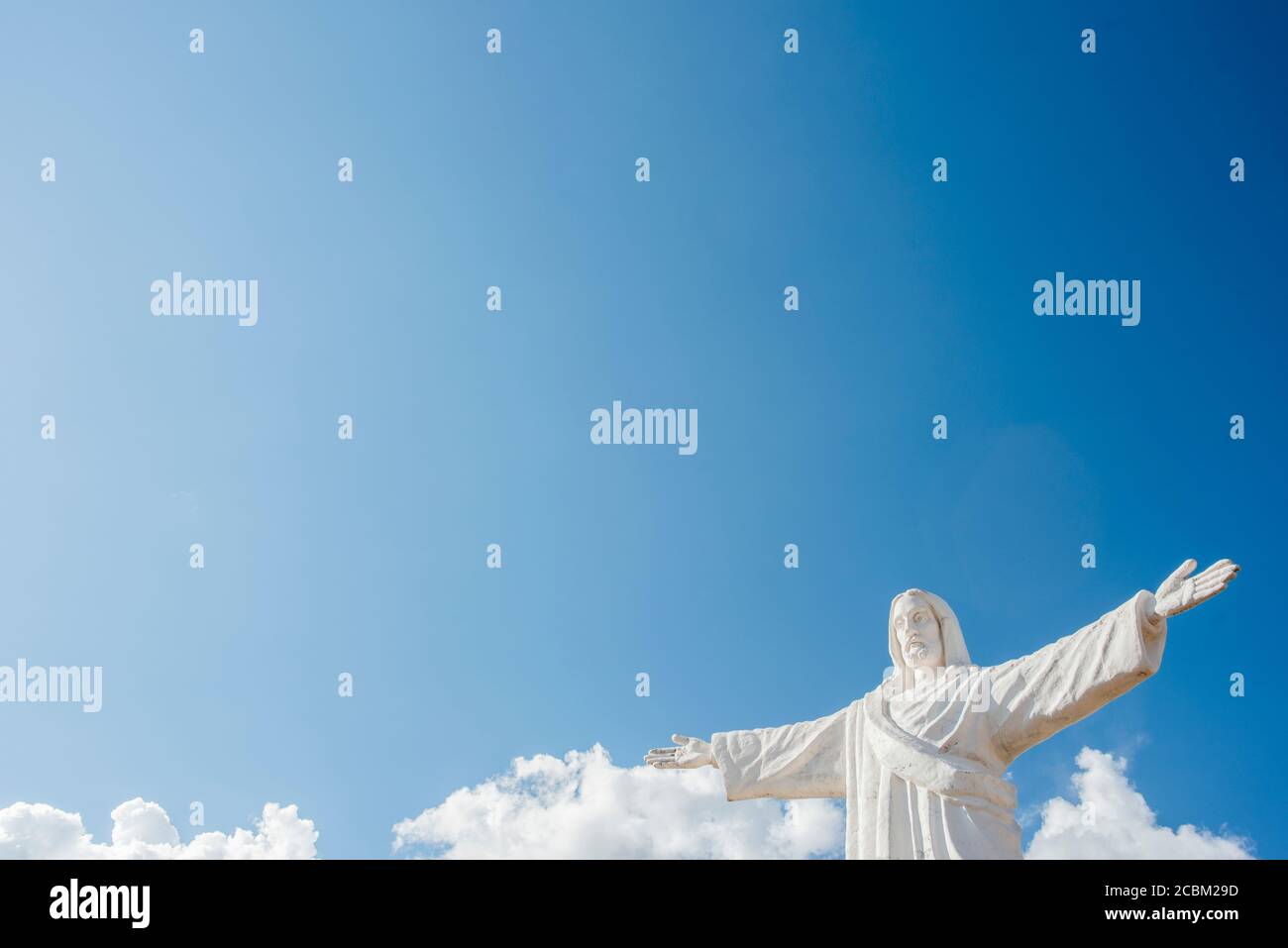 Statue of Christ against blue sky at Sacsayhuaman in Cusco, Peru Stock ...