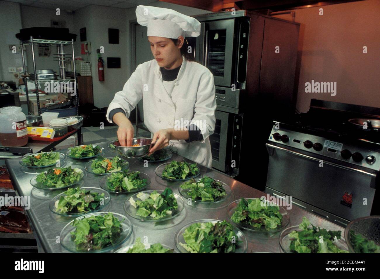 Austin, Texas USA, 1998: Hispanic high school girl in white chef's hat ...