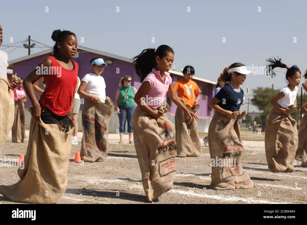 Children jumping sack race hi-res stock photography and images - Alamy