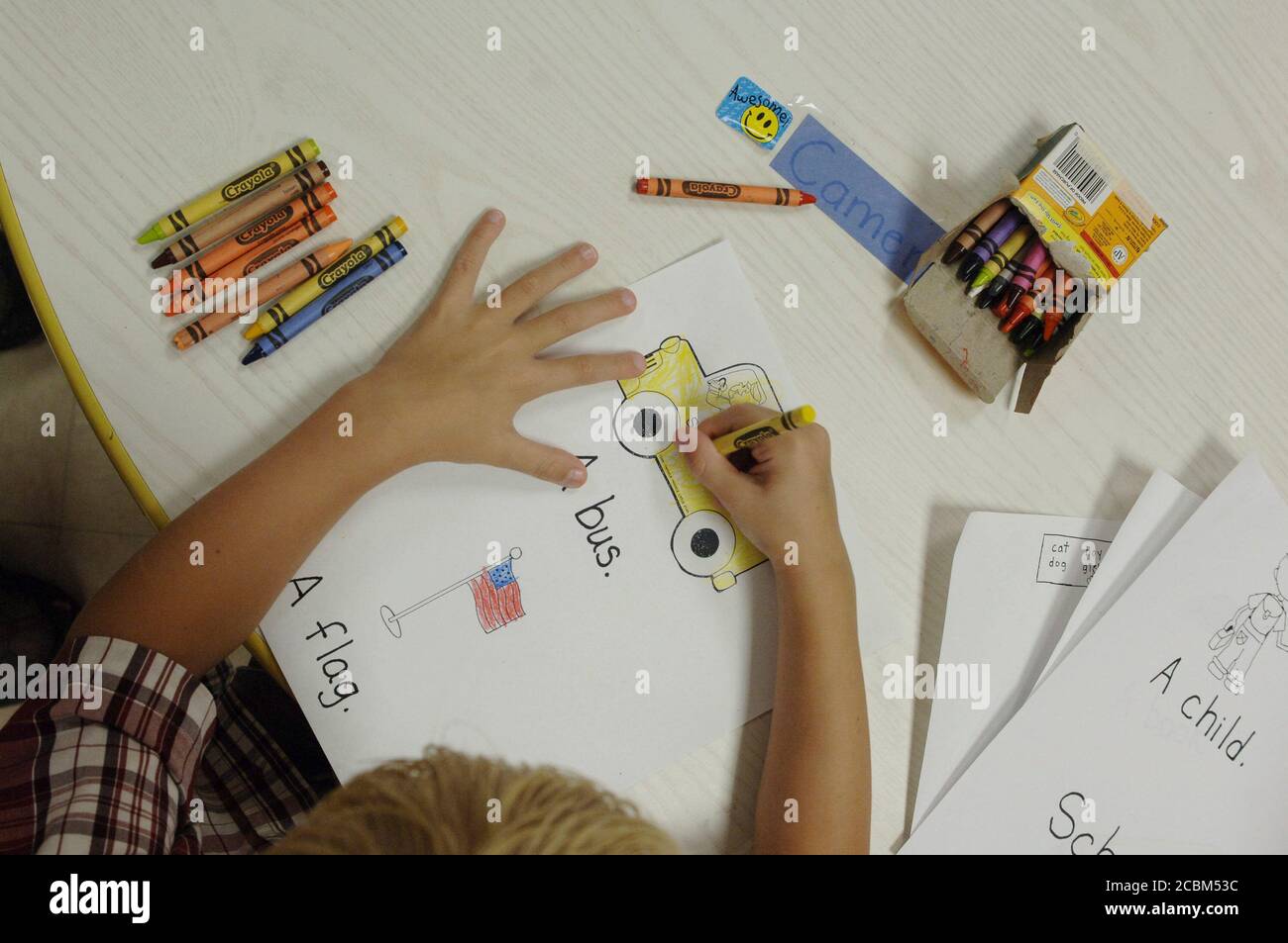 Mabank, Texas USA, August 19, 2006: Kindergarten student uses crayons ...