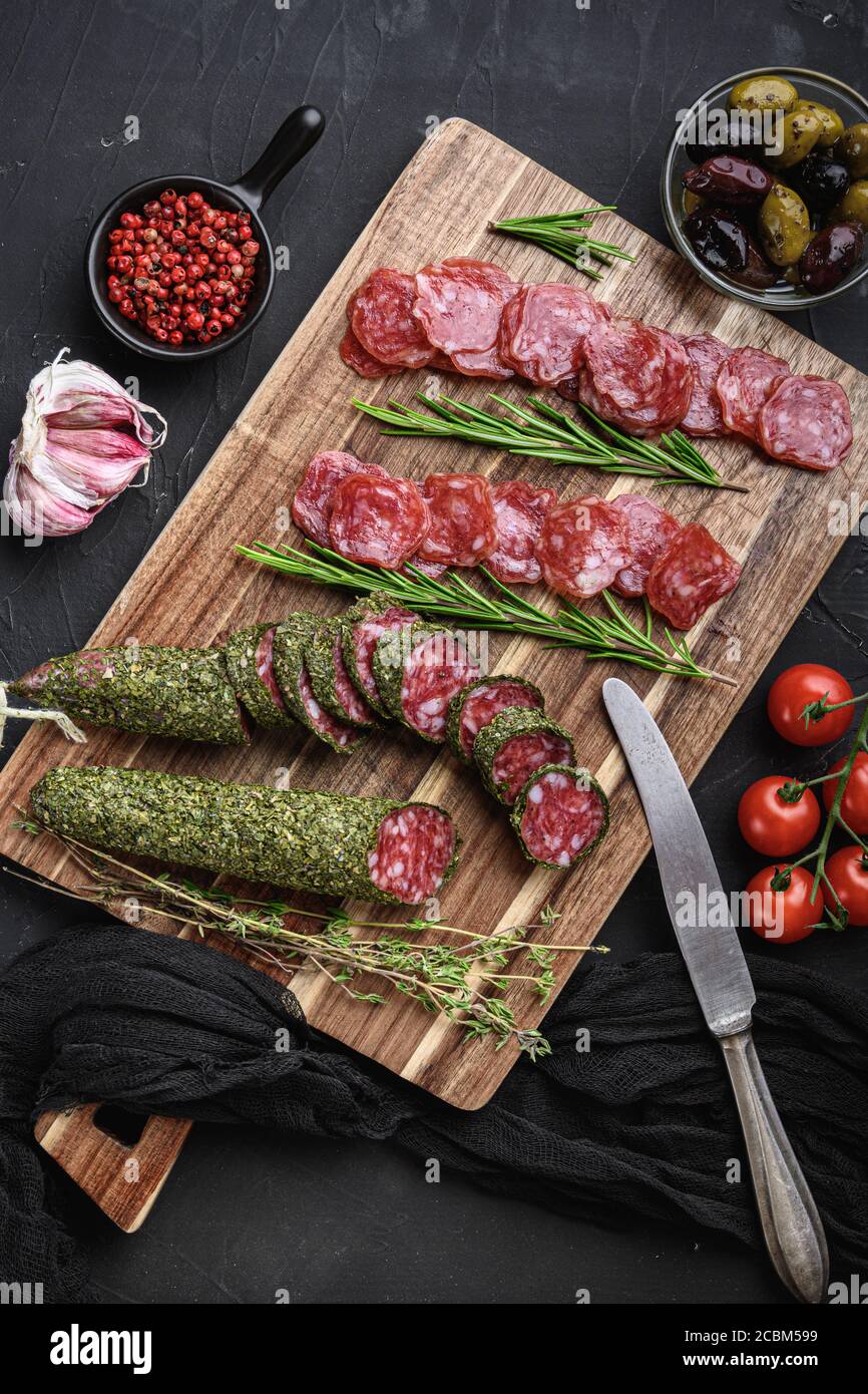 Spanish fuet salami sausage slices on black textured background ...