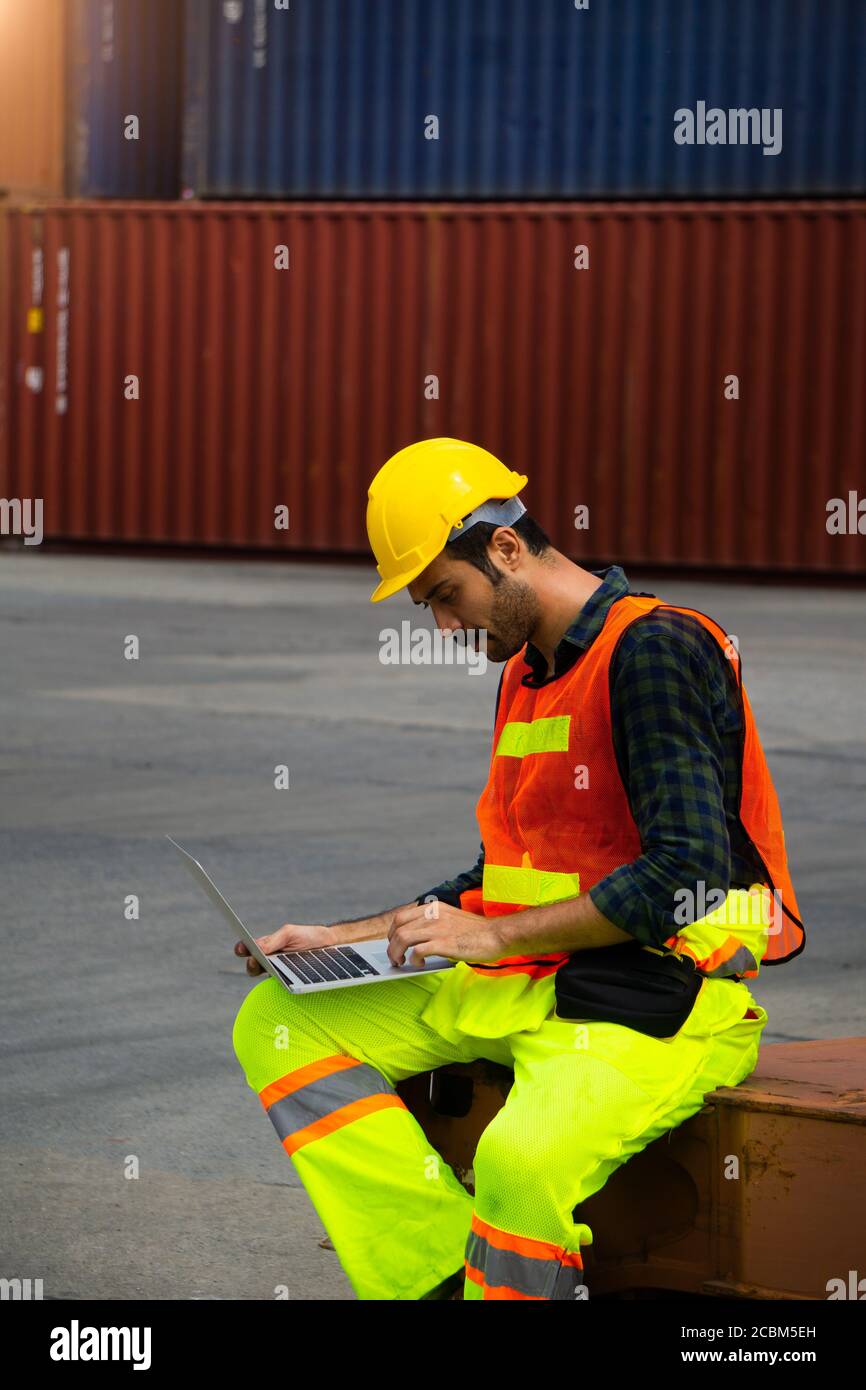 Industrial workers or engineers using computer laptop to control work ...