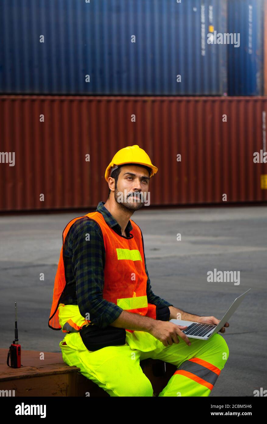 Industrial workers or engineers using computer laptop to control work ...