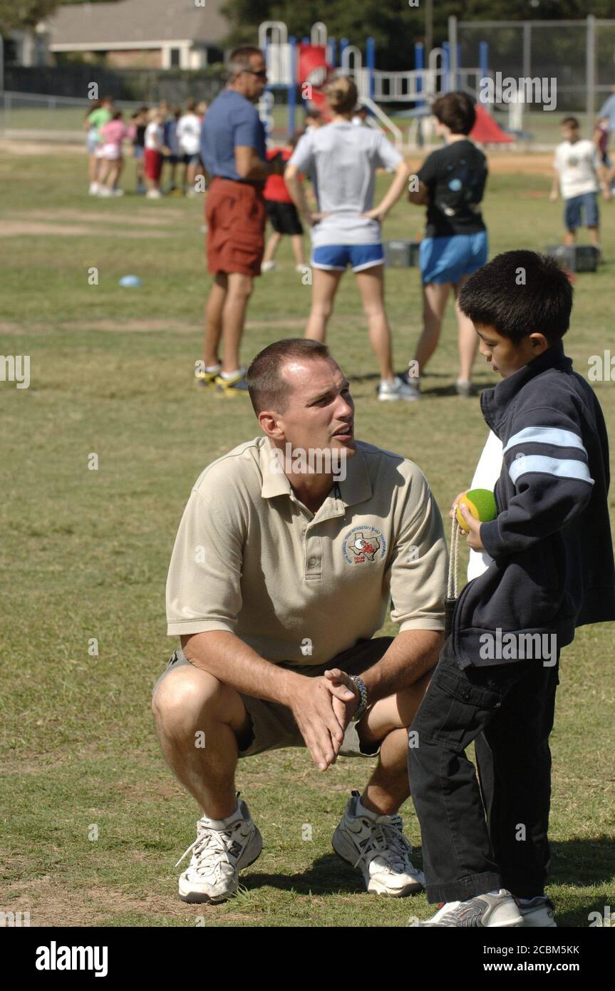 Round Rock, Texas. USA: Male elementary school teacher talks intently ...