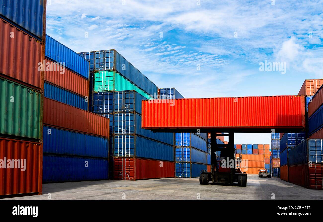 Forklift truck handling container box in shipping industry and cargo ...
