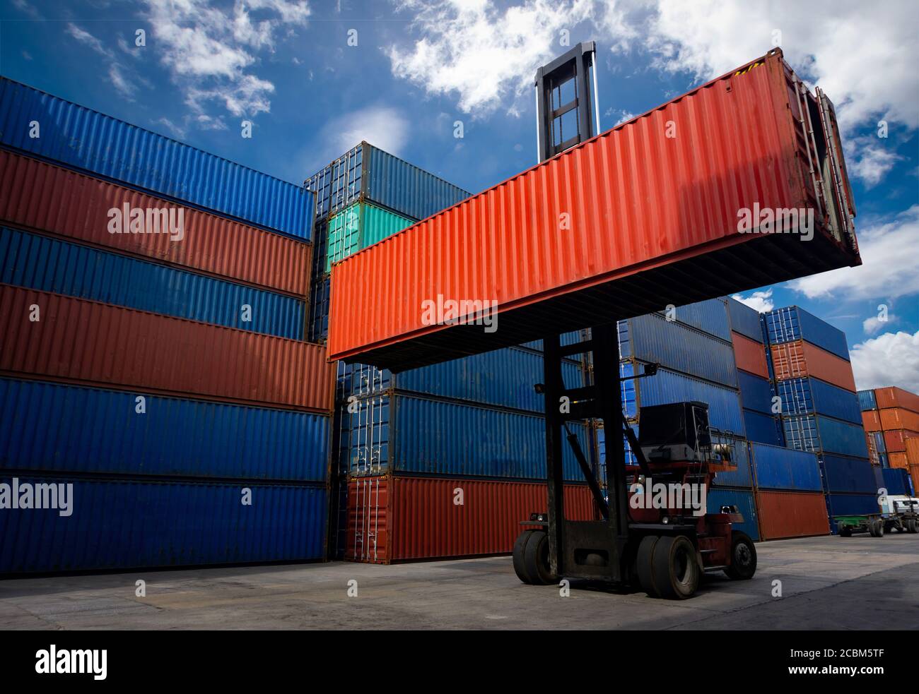 Forklift truck handling container box in shipping industry and cargo ...