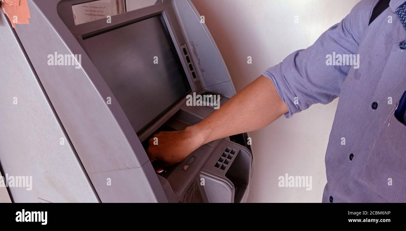 DISTRICT KATNI, INDIA - SEPTEMBER 20, 2019: Man hand withdrawing cash ...