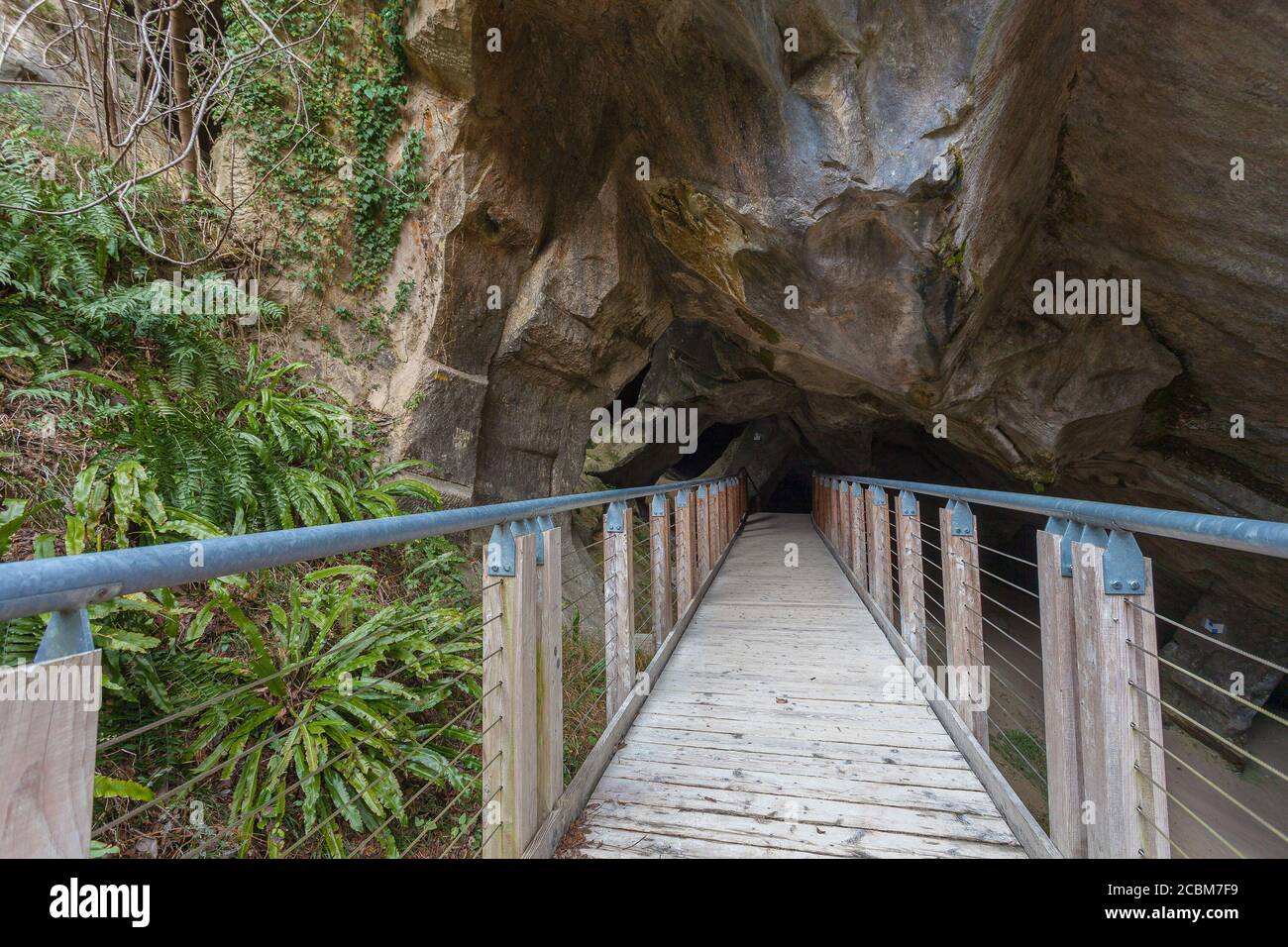 Entrance walkway of caves carved out of sandstone Stock Photo - Alamy