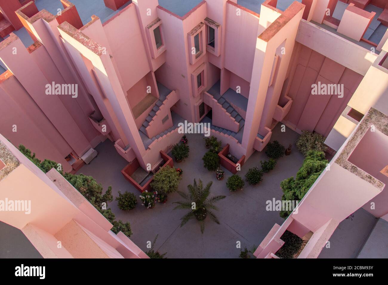 Pink courtyard with uniques stairs Stock Photo - Alamy