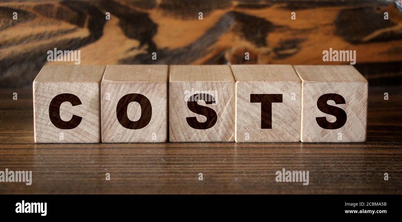Wooden block with word COSTS. Expenses business concept Stock Photo - Alamy