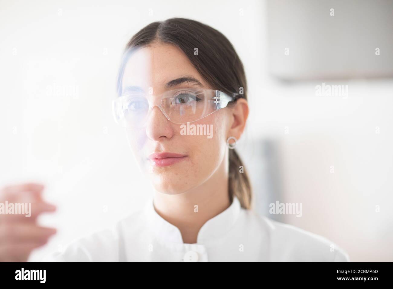scientist female with lab glasses, tablet and sample in a lab Stock ...