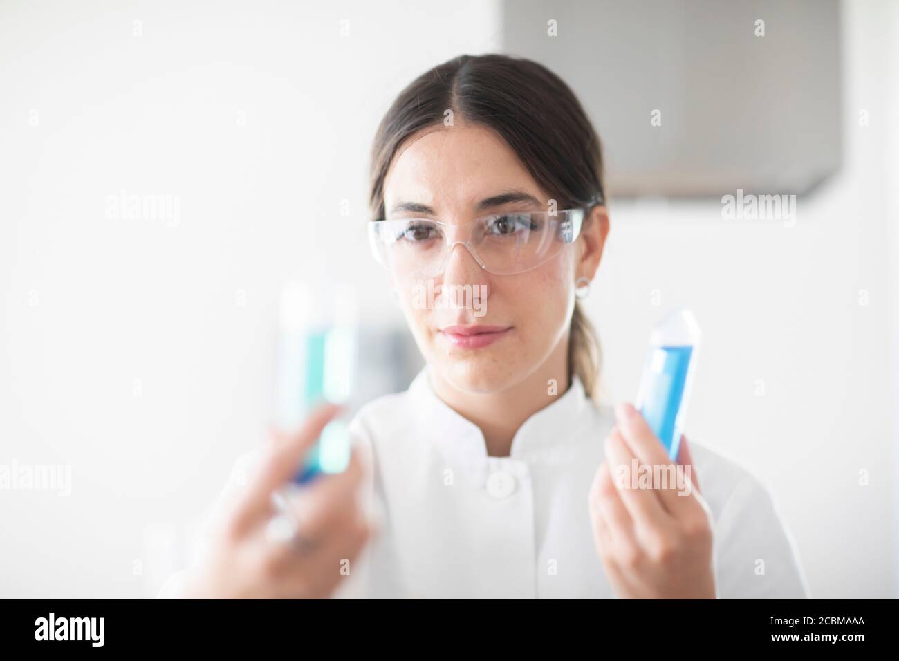 scientist female with lab glasses, tablet and sample in a lab Stock ...