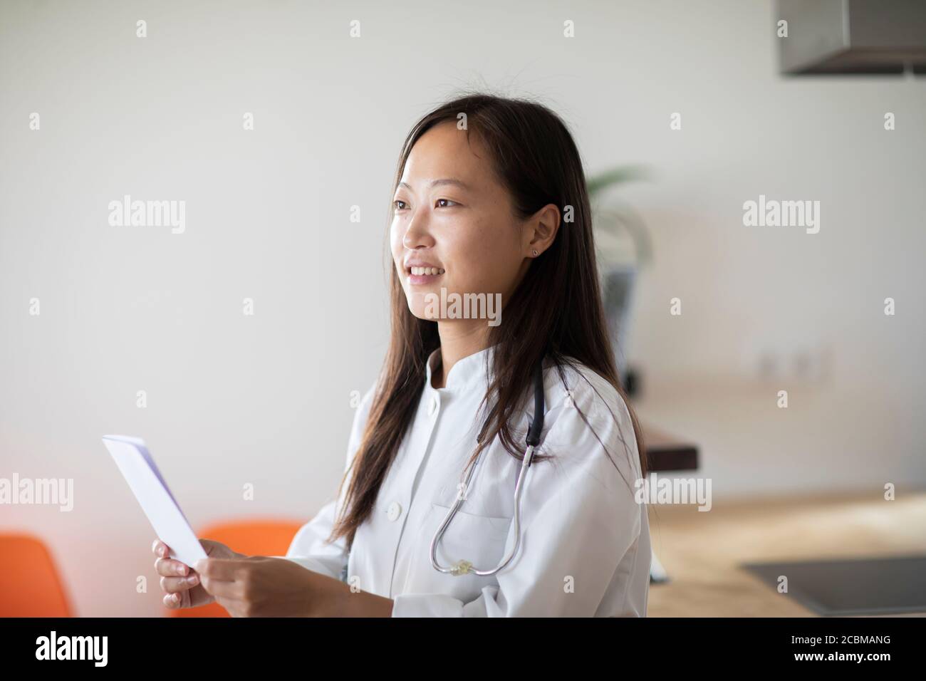 young asia female doctor with report in a practice Stock Photo - Alamy