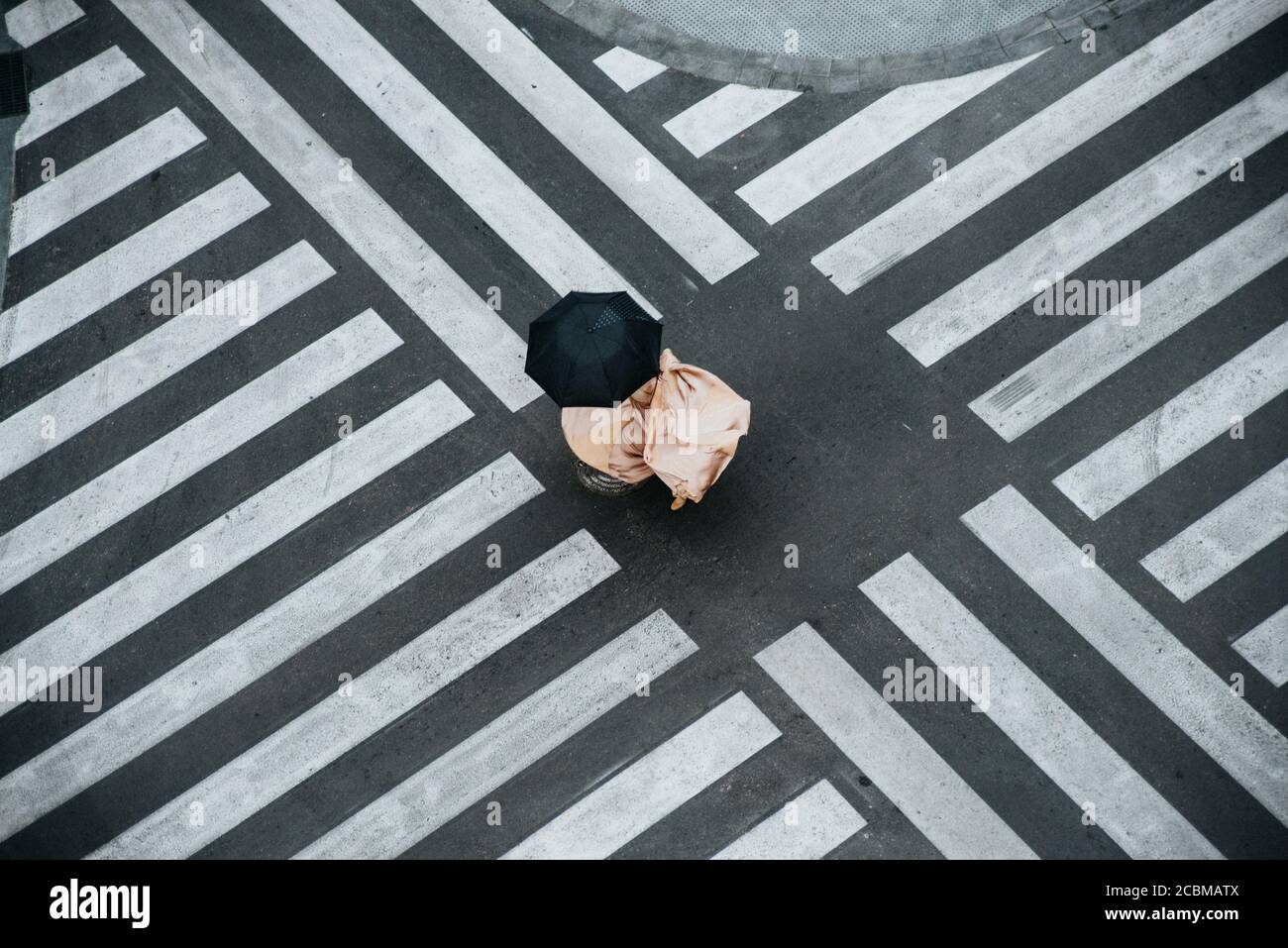 Woman dancing in a zebra crossing with a dress and an umbrella Stock ...
