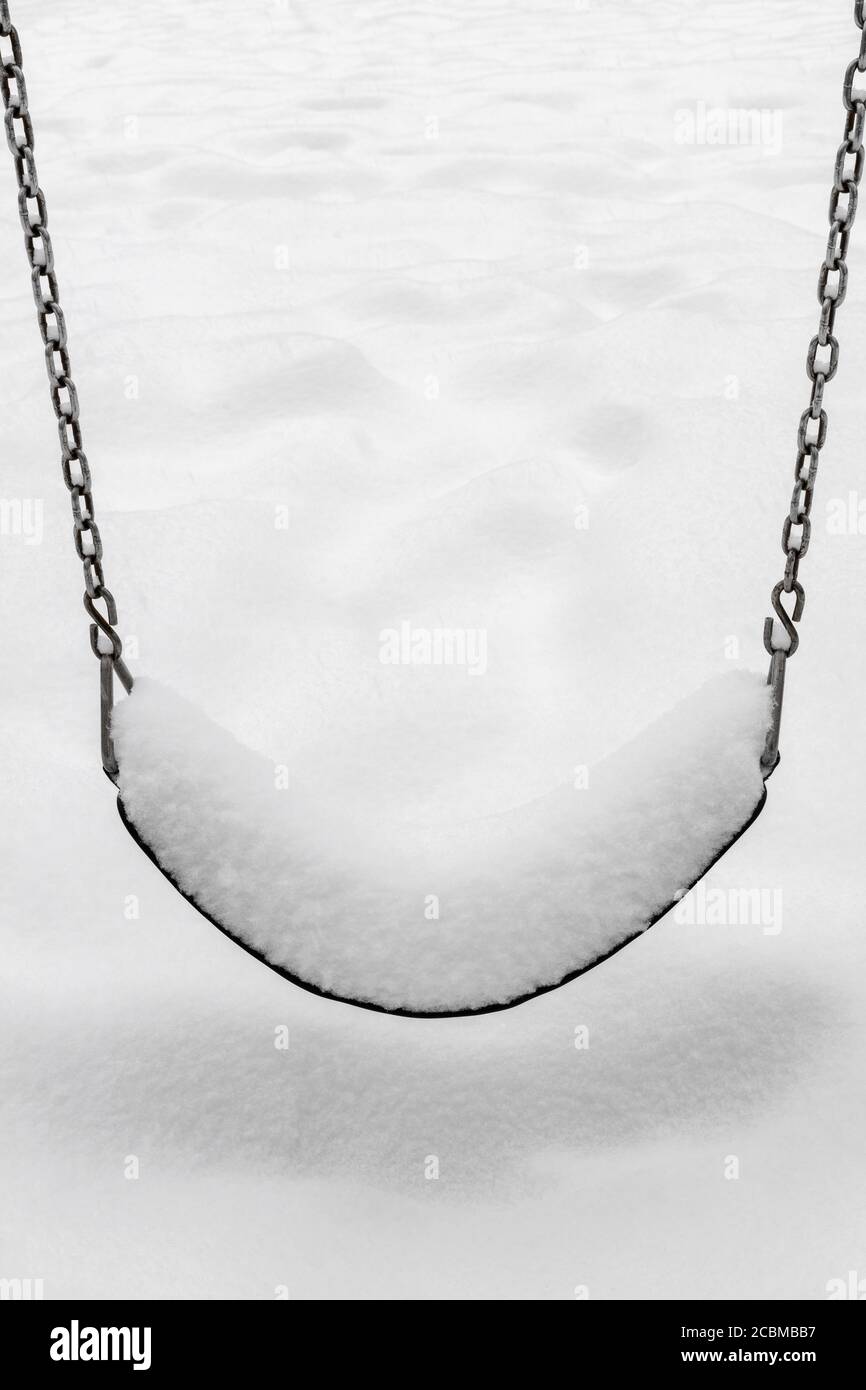 Swing covered with Snow Stock Photo - Alamy