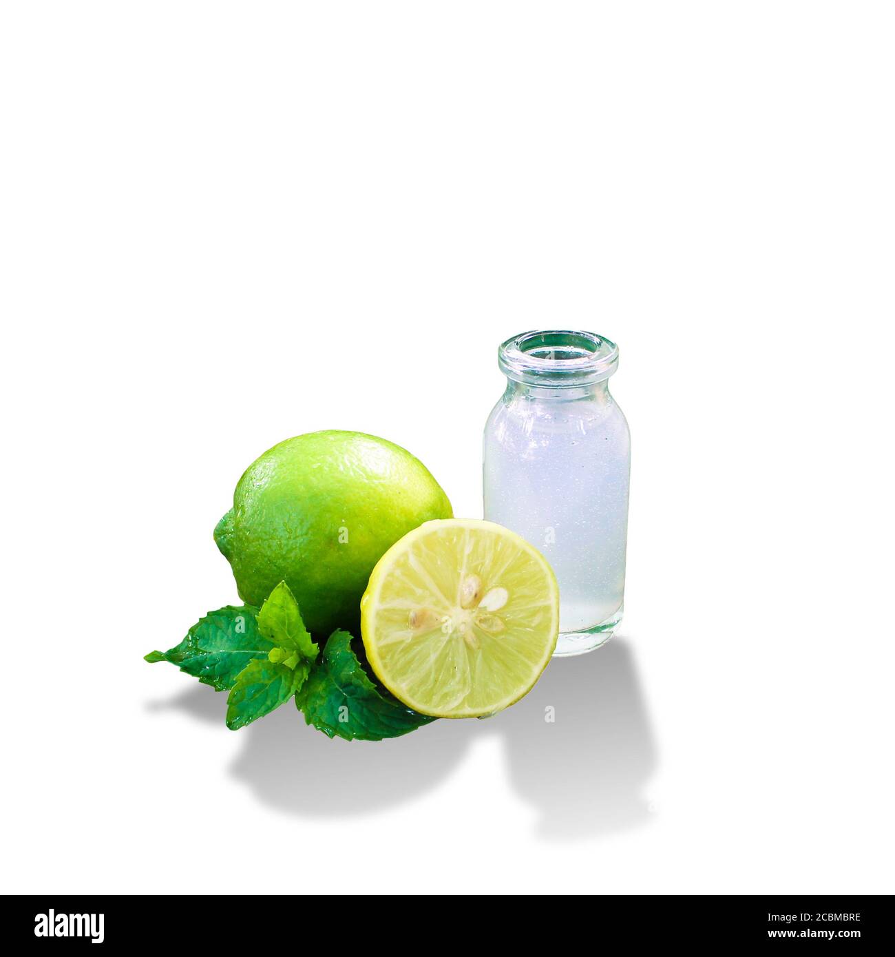 Green Lemons and lemon juice in a jar isolated with white background ...