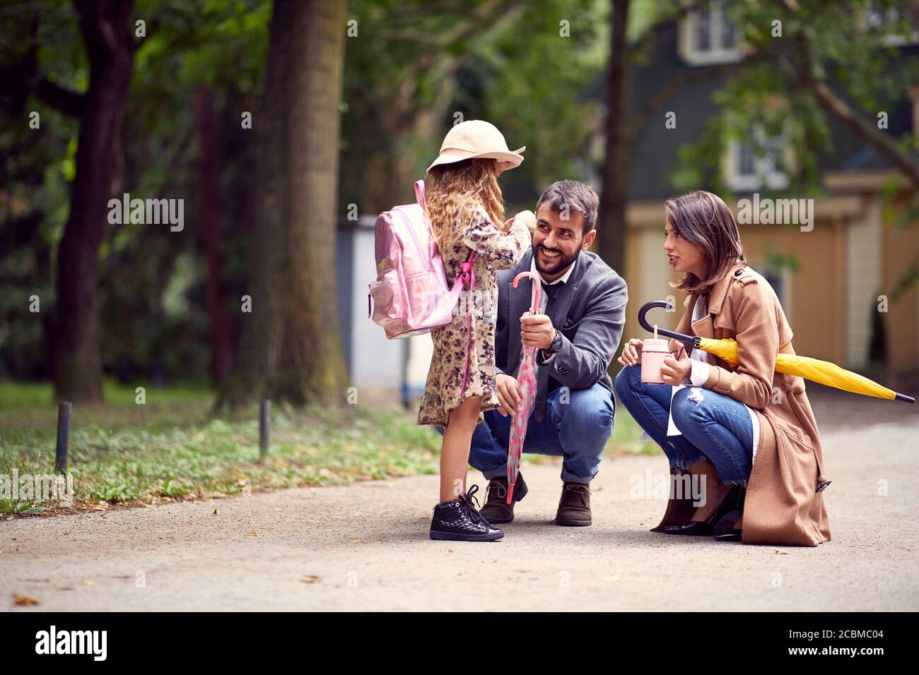 Mom and dad talking with daughter after school Stock Photo - Alamy