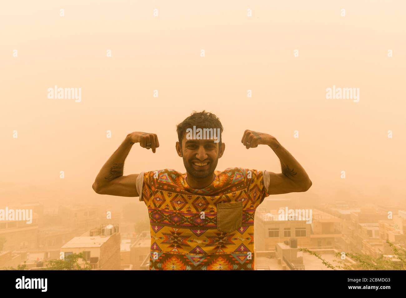 man showing off his physique outdoor during sandstorm Stock Photo - Alamy