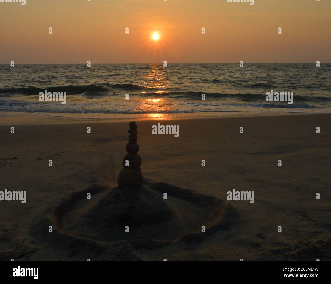 Image shows setting sun at the beach. A sunset represents ending ...