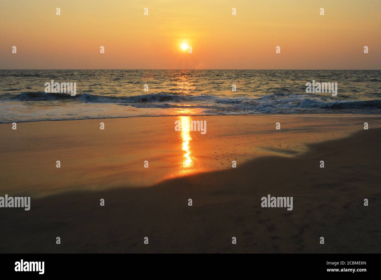 Image shows setting sun at the beach. A sunset represents ending ...