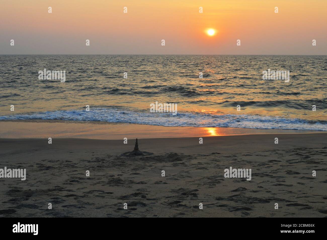 Image shows setting sun at the beach. A sunset represents ending ...