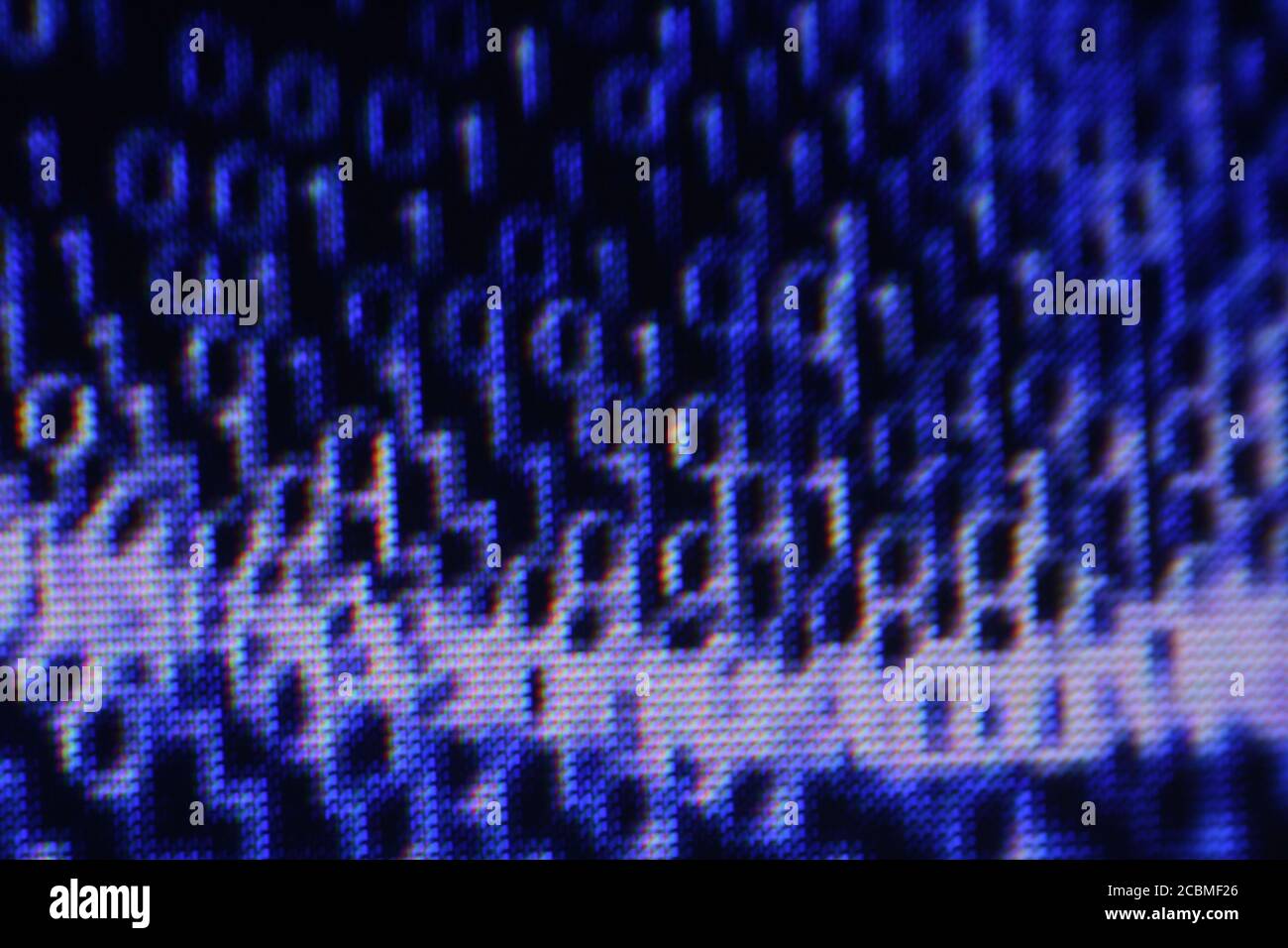 Closeup shot of blue blurred screen displaying compacted binary codes ...
