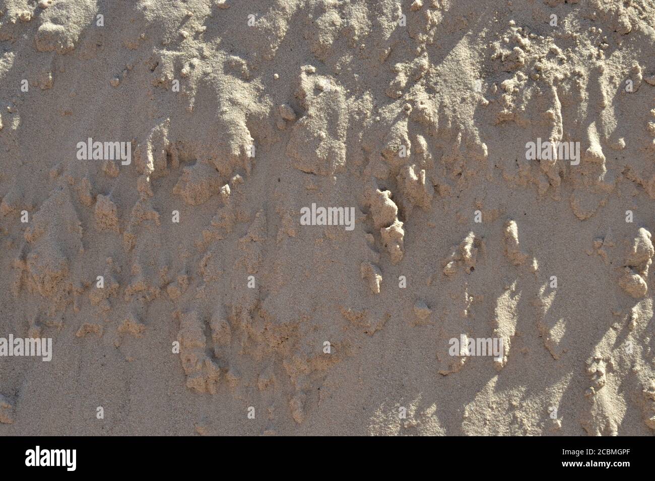 River sand for construction with small stones with shadows photographed ...