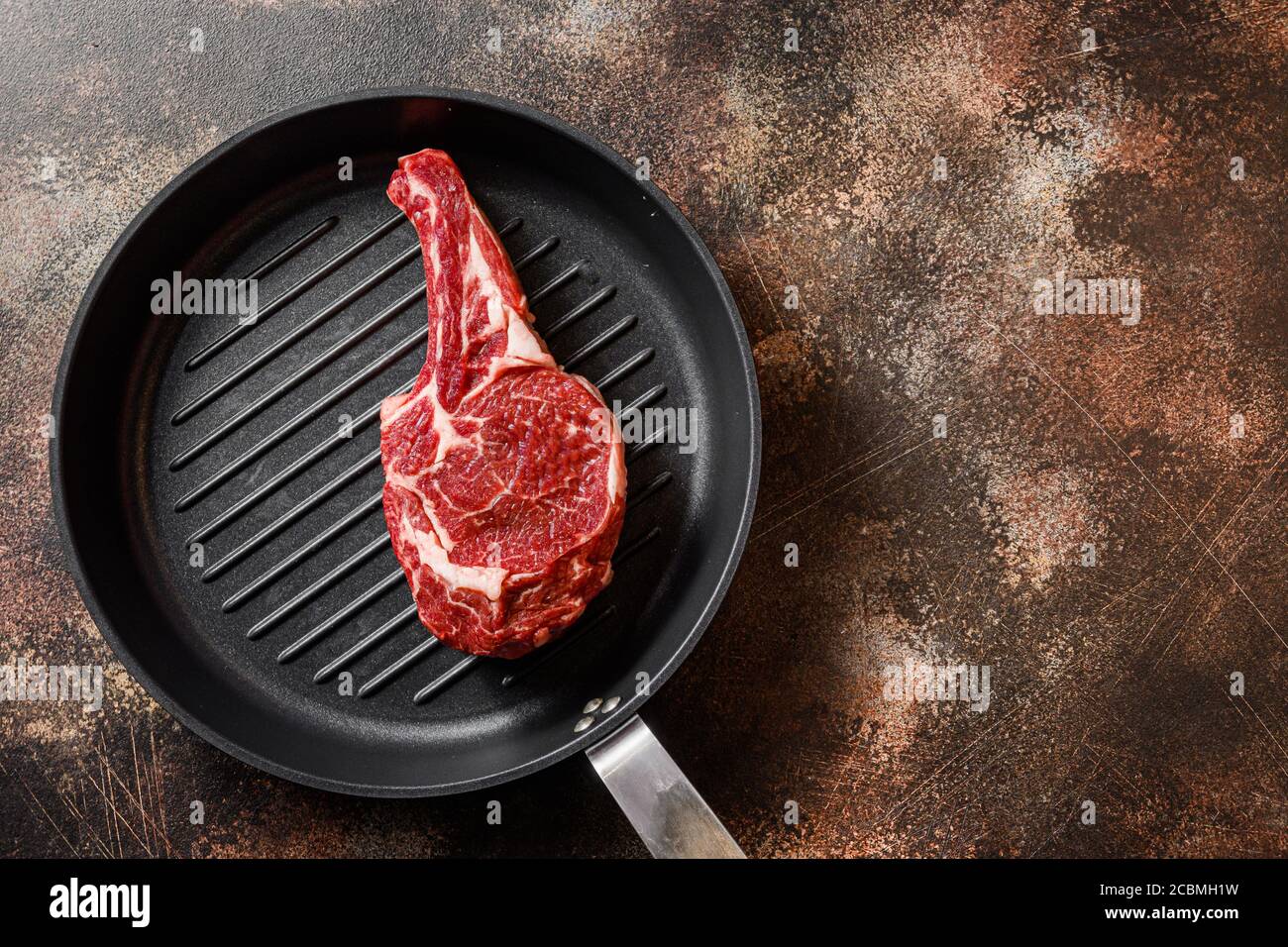 Spencer steak on the grill pan skillet or Scotch Fillet raw top view ...