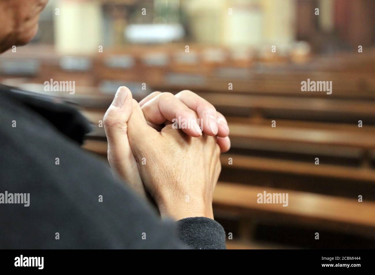 Symbol image: Devout Christian praying in a church (Model released ...