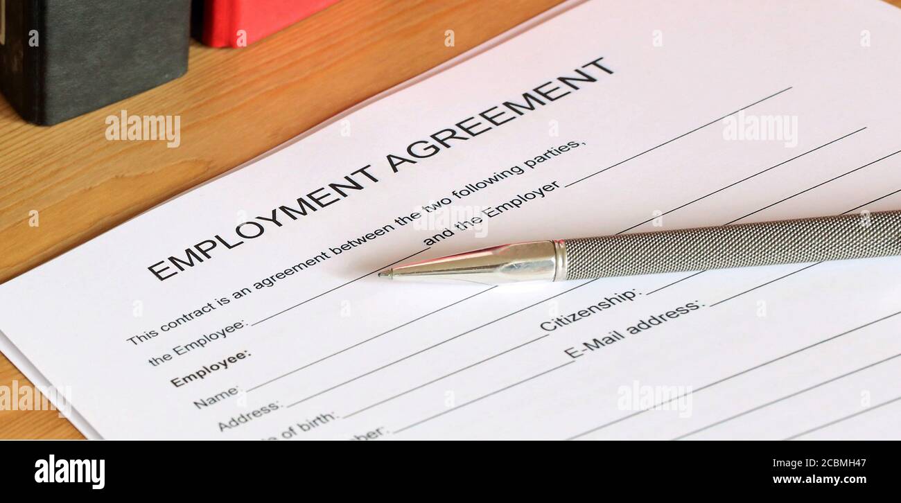 Symbol image: Blank form of an employment agreement on a desk Stock ...