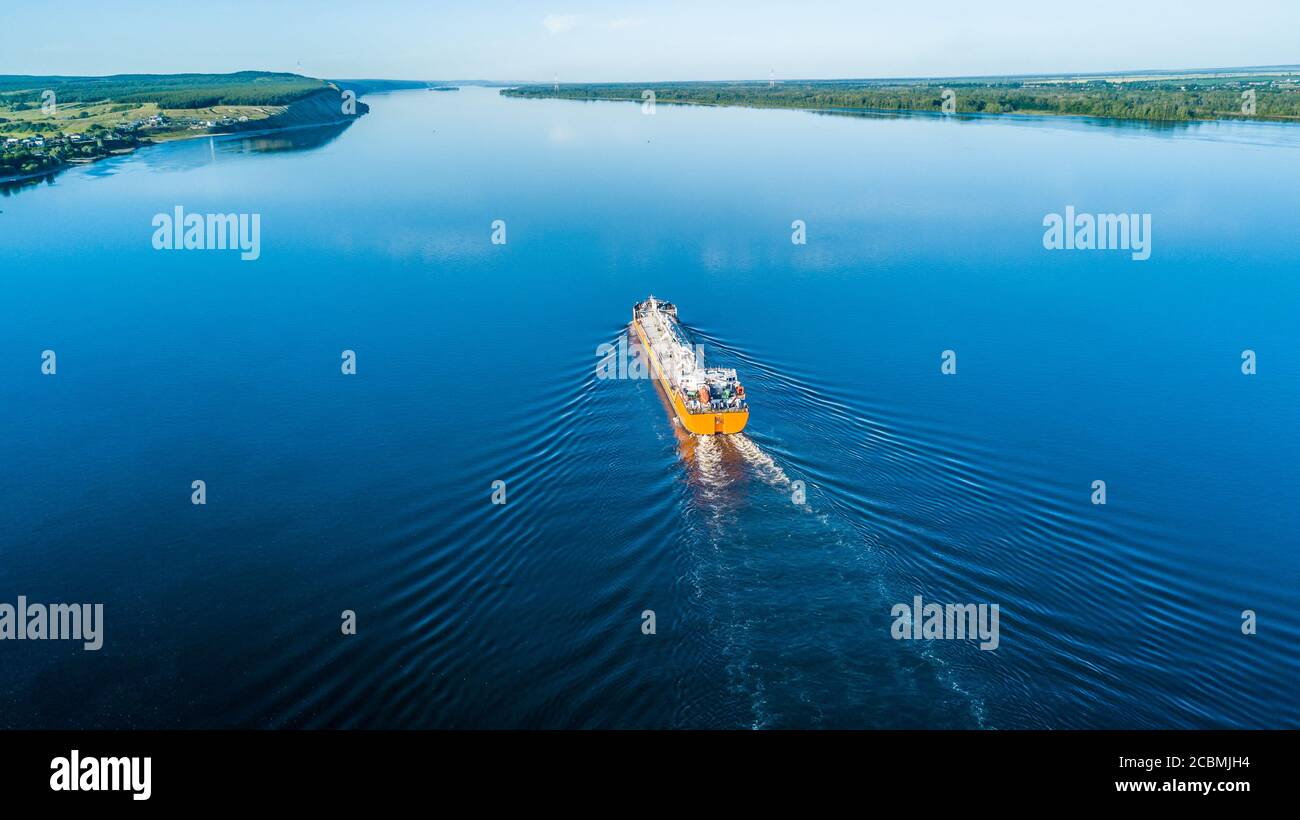A large oil-filled river tanker of orange-black color Stock Photo - Alamy