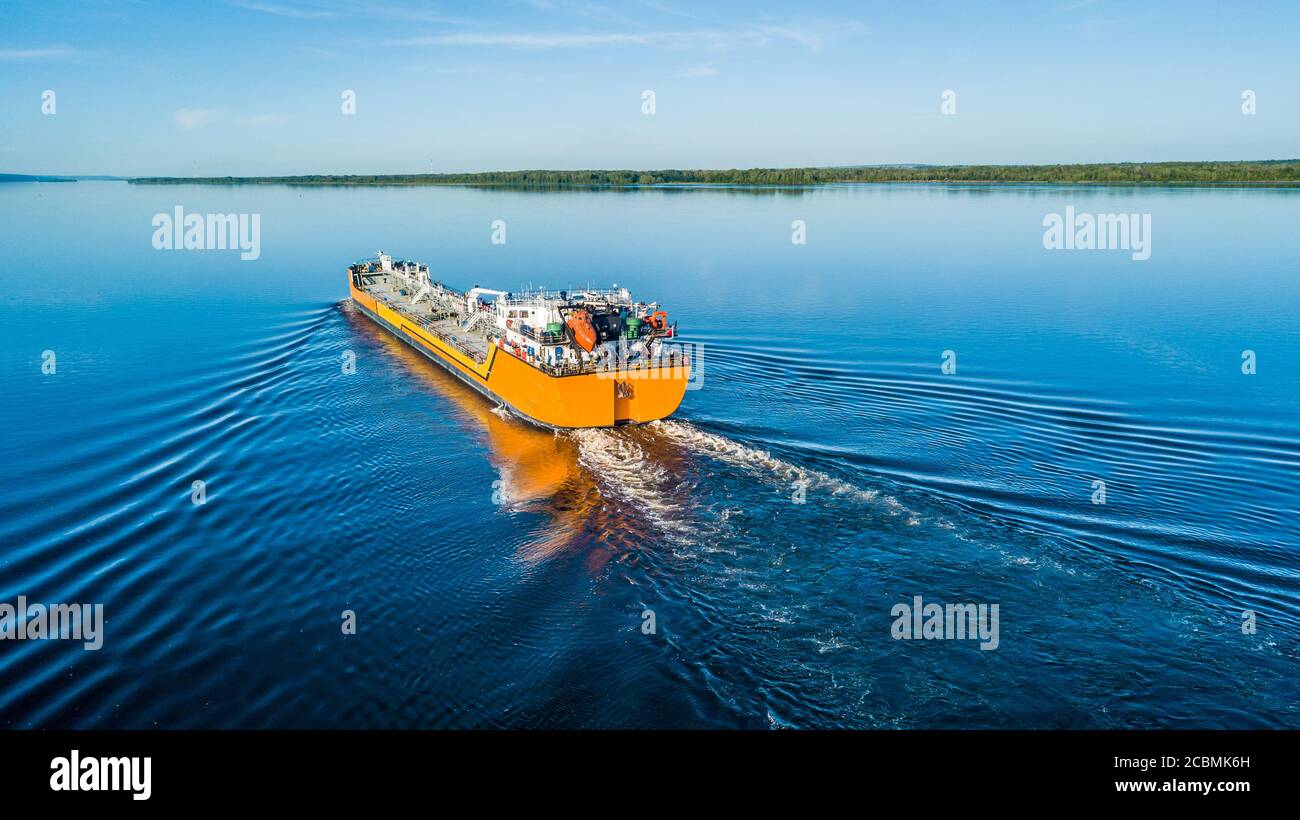 A large oil-filled river tanker of orange-black color Stock Photo - Alamy