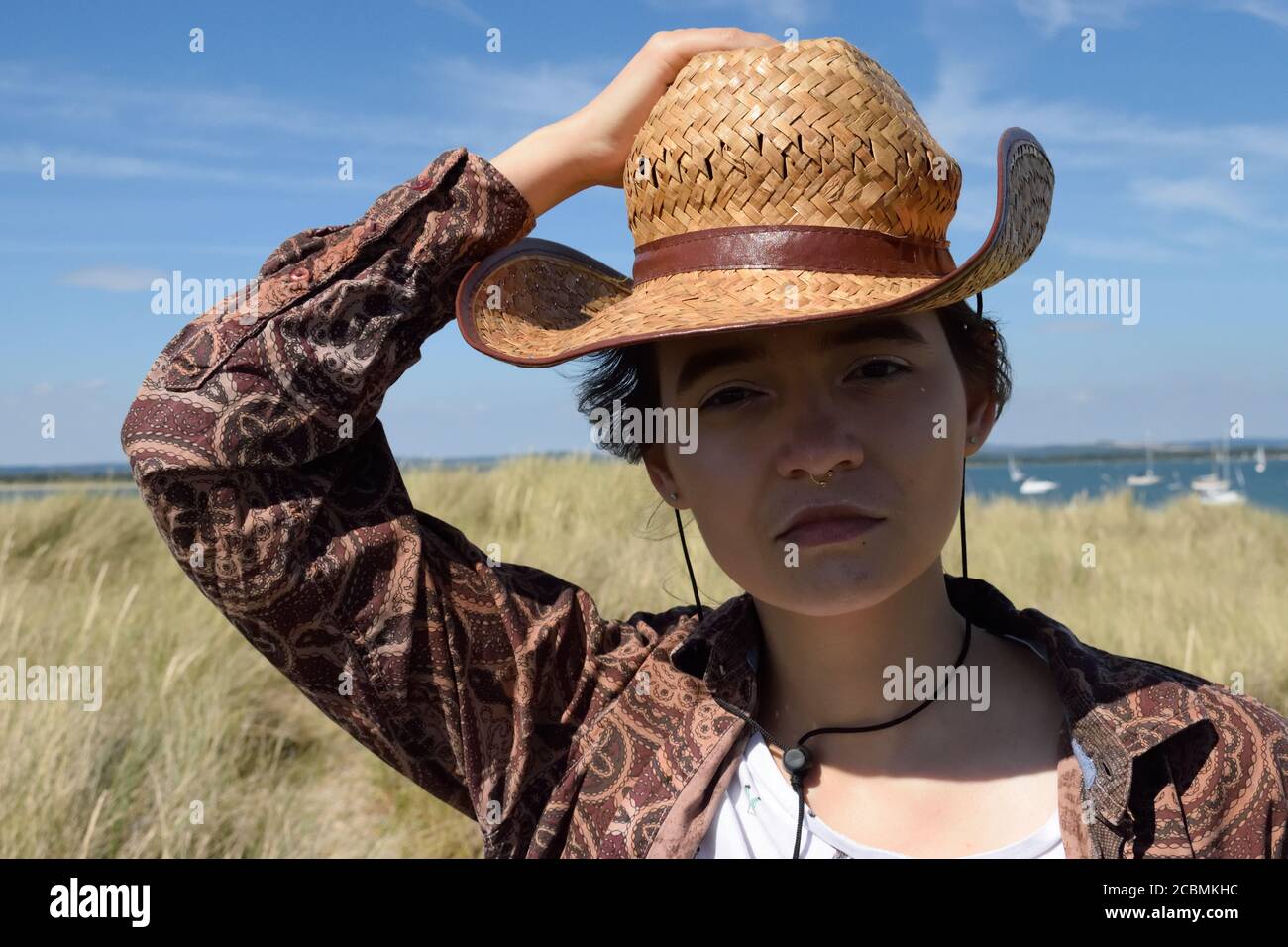 Young Person in Cowboy Hat By the Sea Stock Photo - Alamy