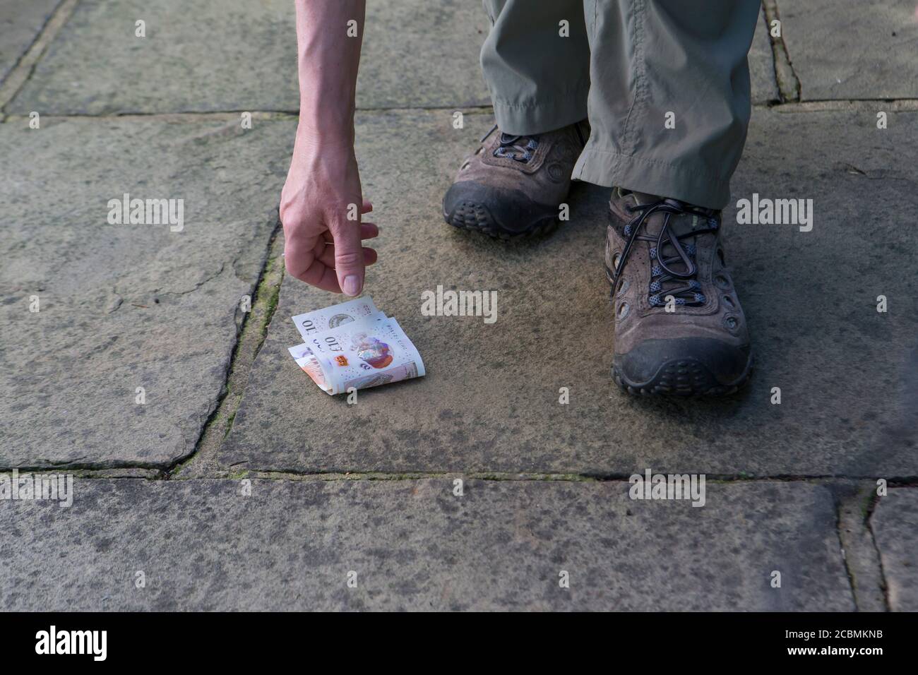 Finding cash on the ground Stock Photo - Alamy