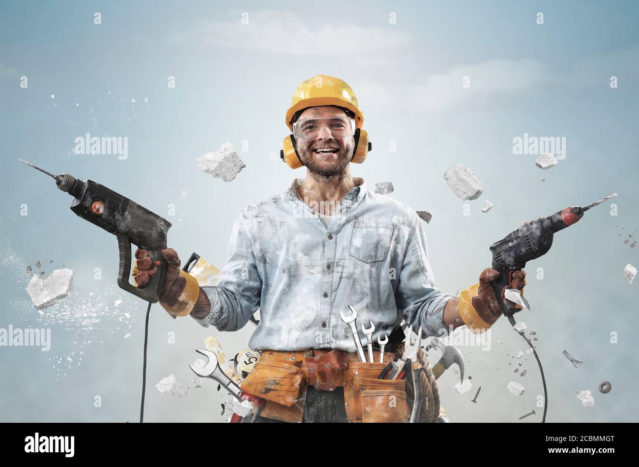 Construction worker with a hammer and drill at work Stock Photo - Alamy