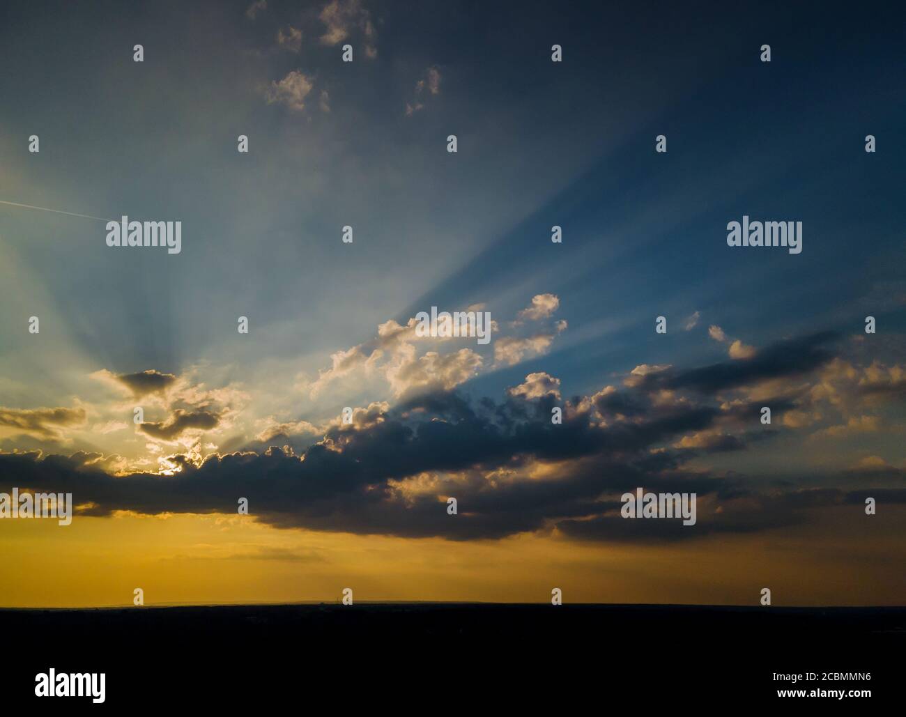 Large beautiful sun beam orange sunset sky dramatic sunset over clouds ...