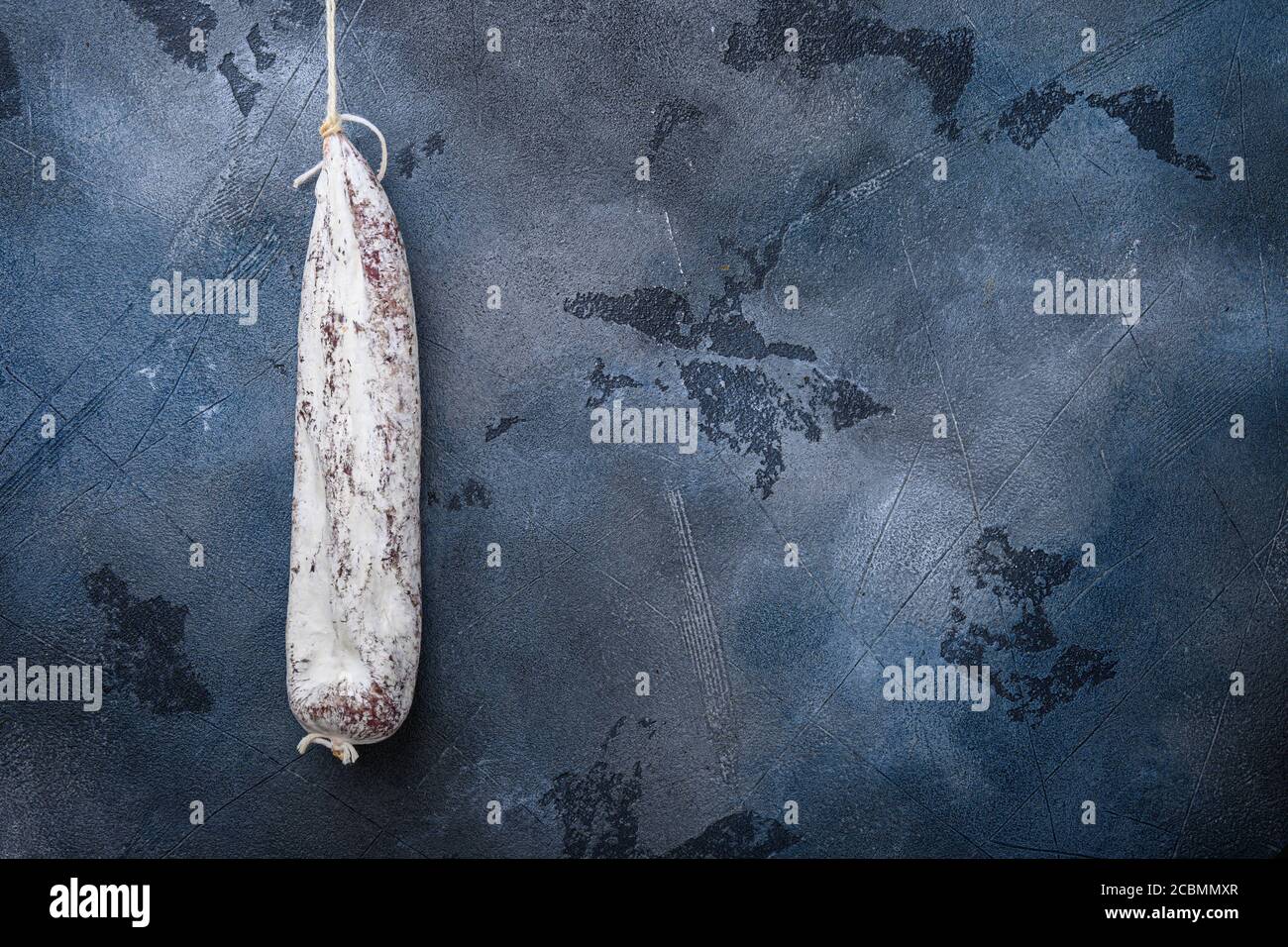 Whole spanish longaniza wurst on blue background, flat lay with copy ...